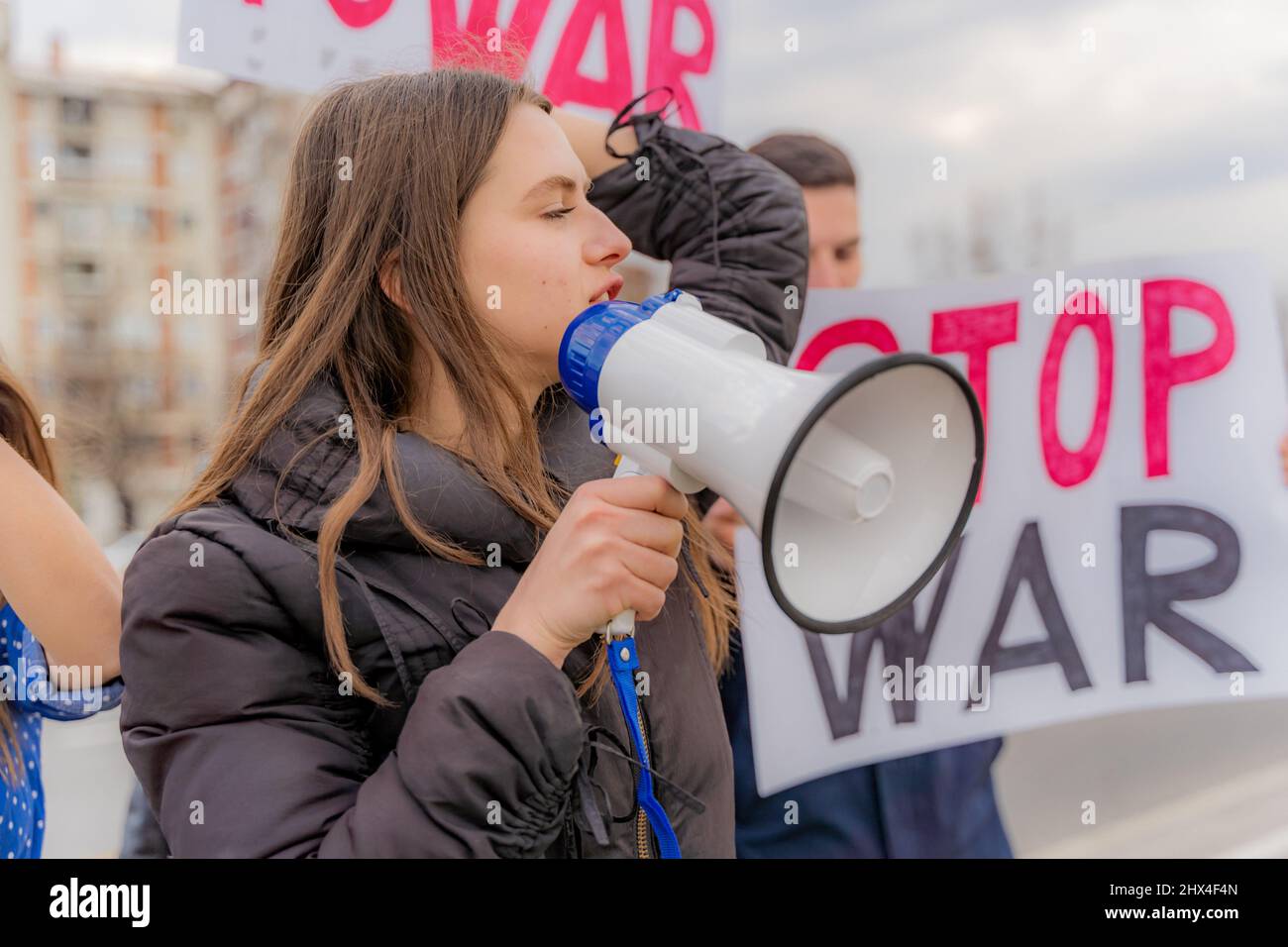 Group of young people are holding the protest signs and shouting ...