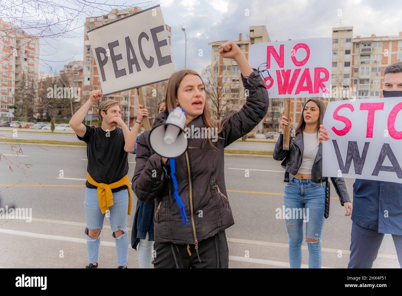 Group of beautiful young people are protesting for world peace together ...