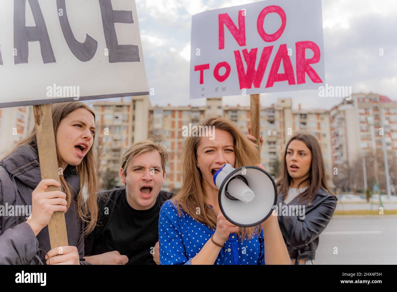 Group of beautiful and sad people are protesting to stop the war while ...