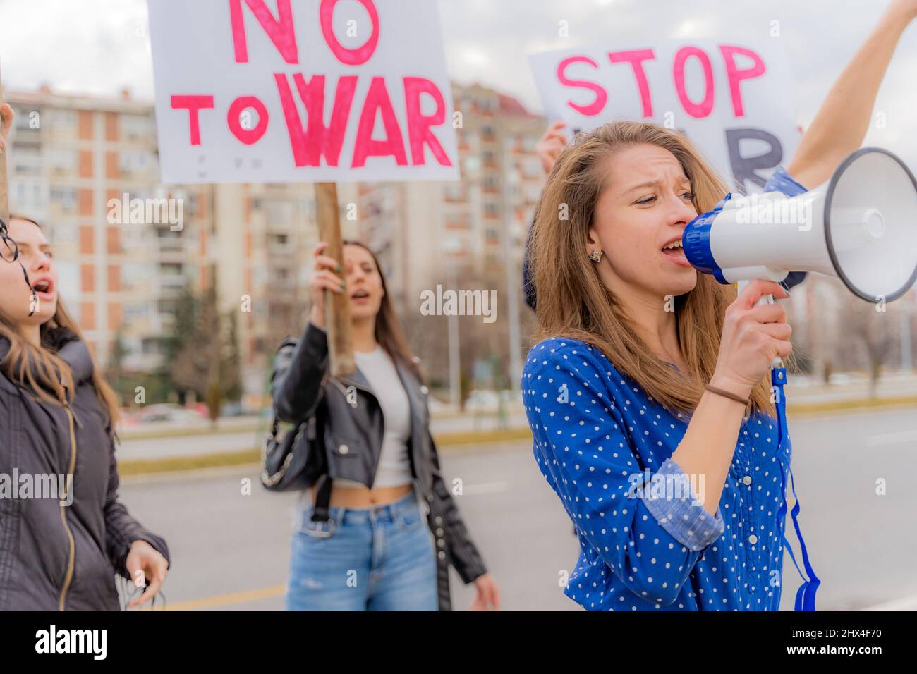 Beautiful and sad girl is having a speech while protesting with her ...