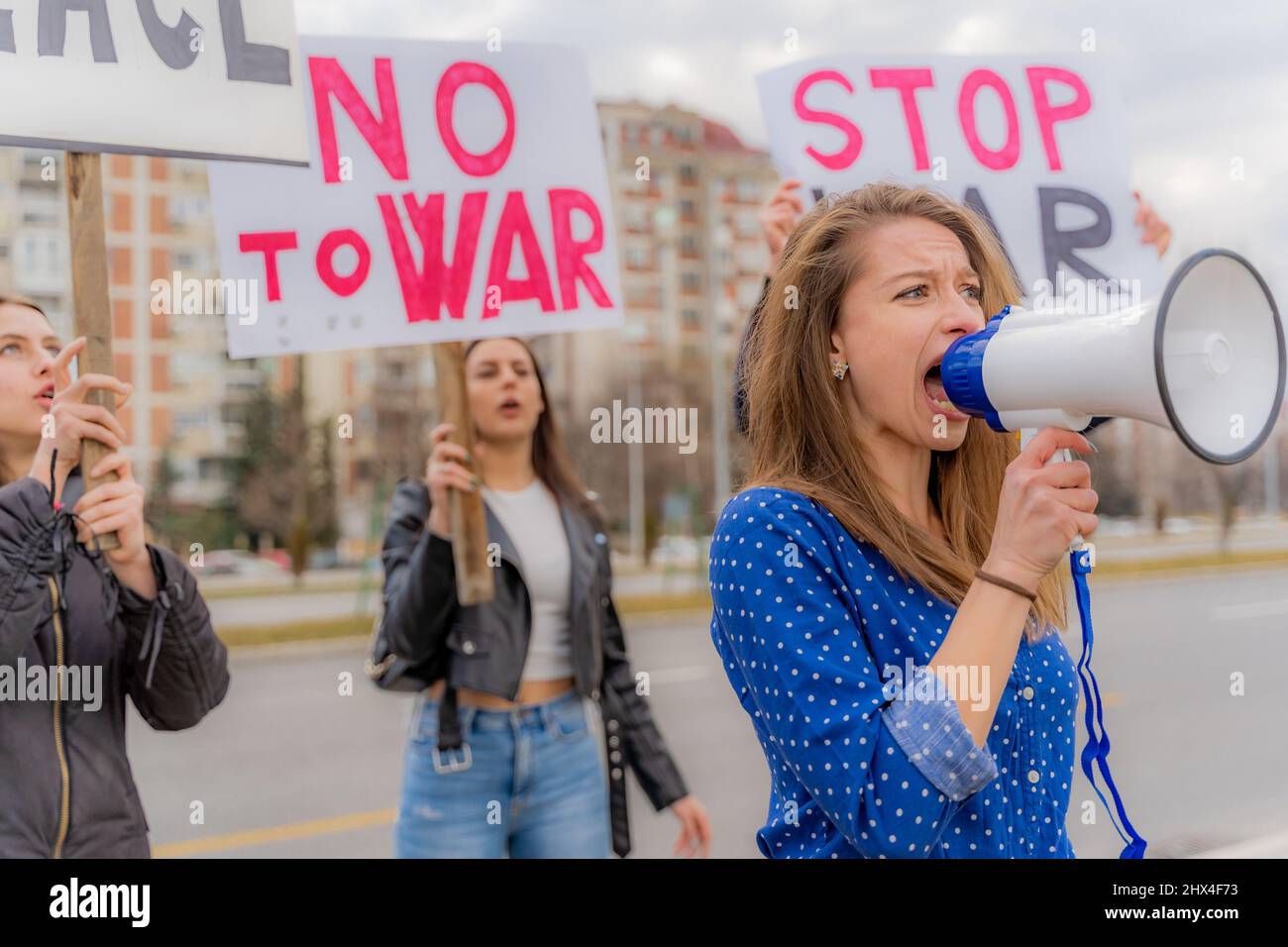 Beautiful and sad girl is loud shouting on the megaphone Stock Photo ...