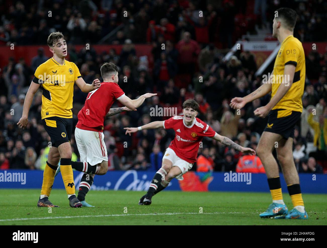 Manchester United's Charlie McNeill (second left) celebrates scoring ...
