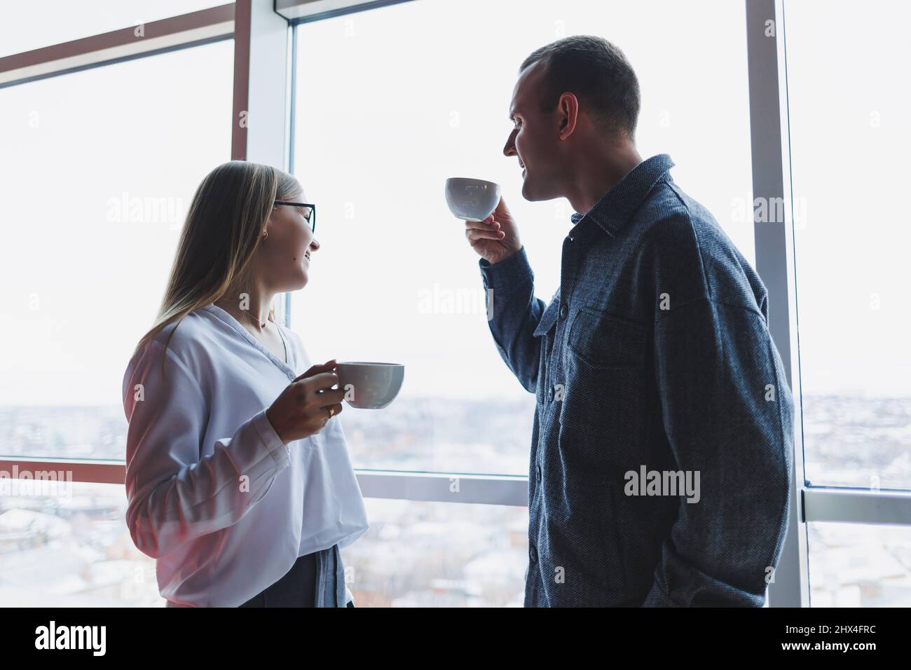 Handsome male businessman and young business woman are standing and ...