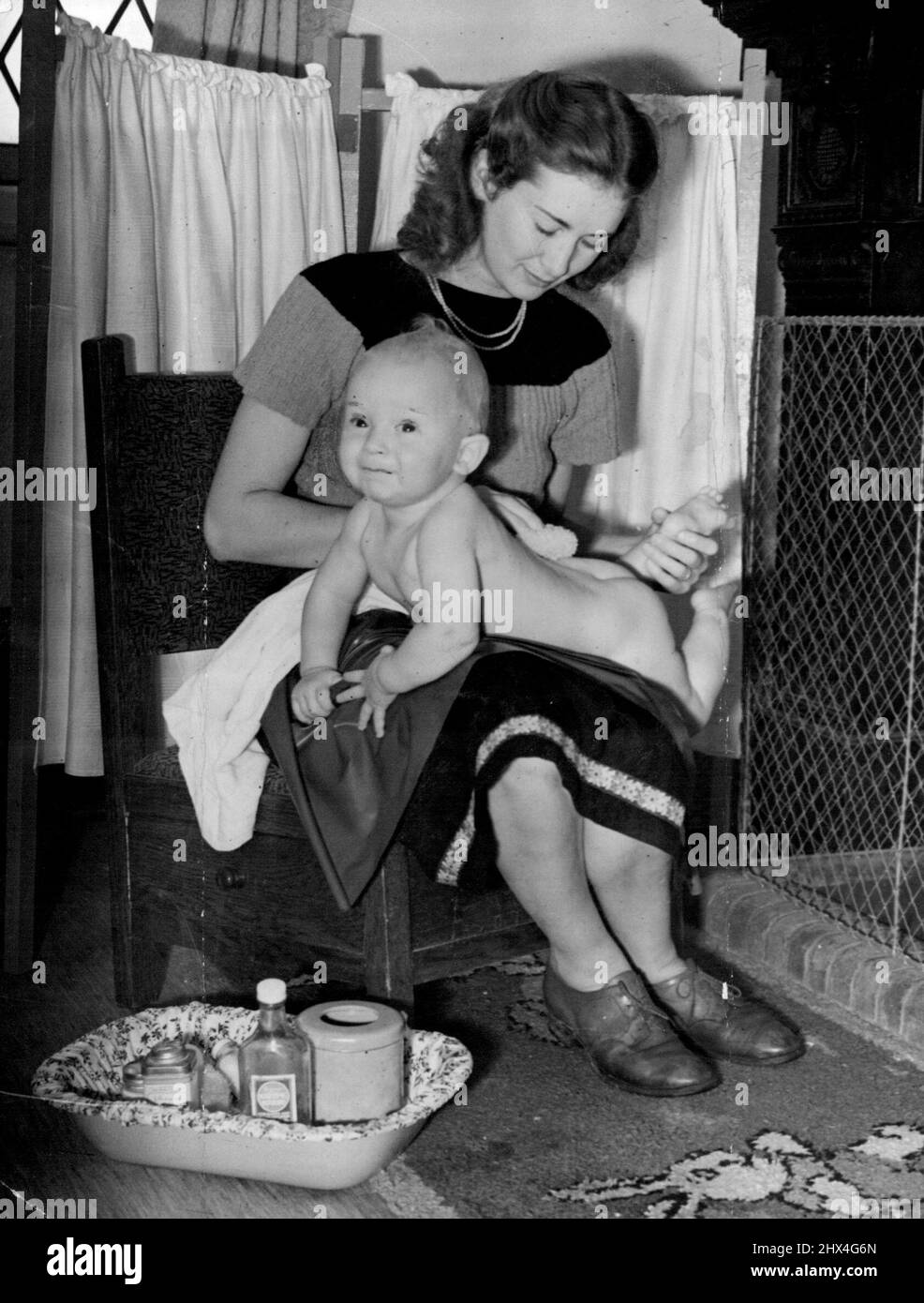 Family make - up -- Nine-months-old "extra" Jeremy Hanley gets his ...