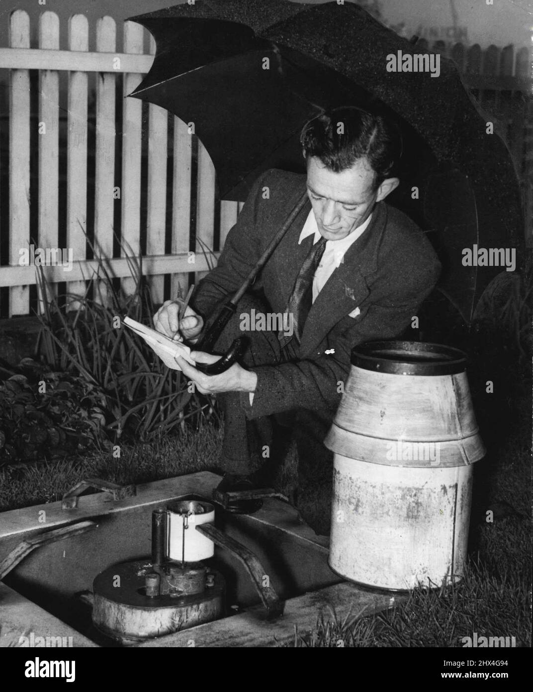 Mr. E. Metcalfe, an assistant at the Sydney Weather Bureau, checking ...