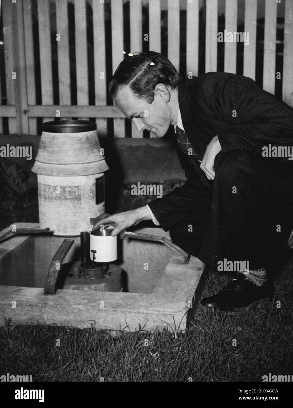 A Weather Bureau official checks the pluviometer (automatic rain ...