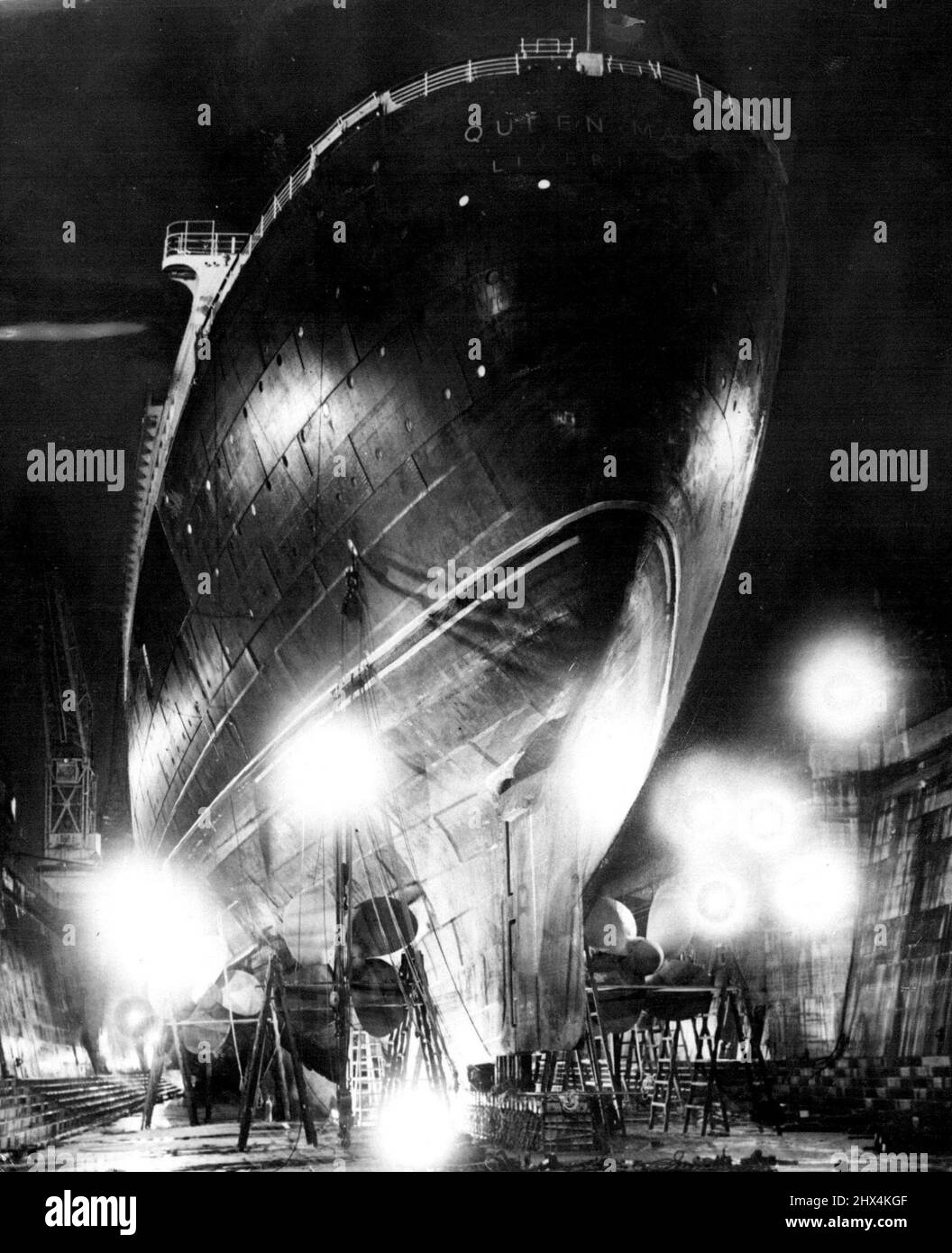 Floodlight On The 'Q.M.' -- Towering above the king George V drydock at ...