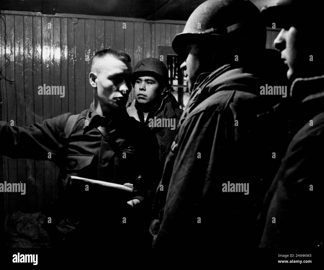 At a predawn briefing, the lieutenant reminds his patrol to stay alert ...