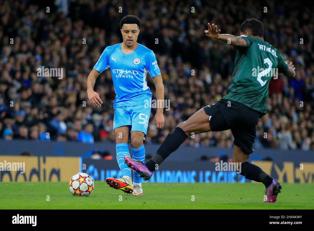 Conrad Egan-Riley #56 of Manchester City is challenged by Matheus Reis ...
