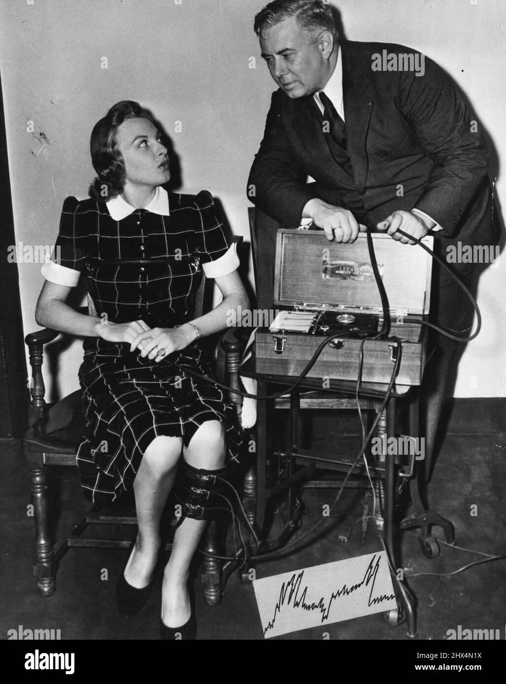 Cardiograph machine (at work on patient). August 7, 1953 Stock Photo ...