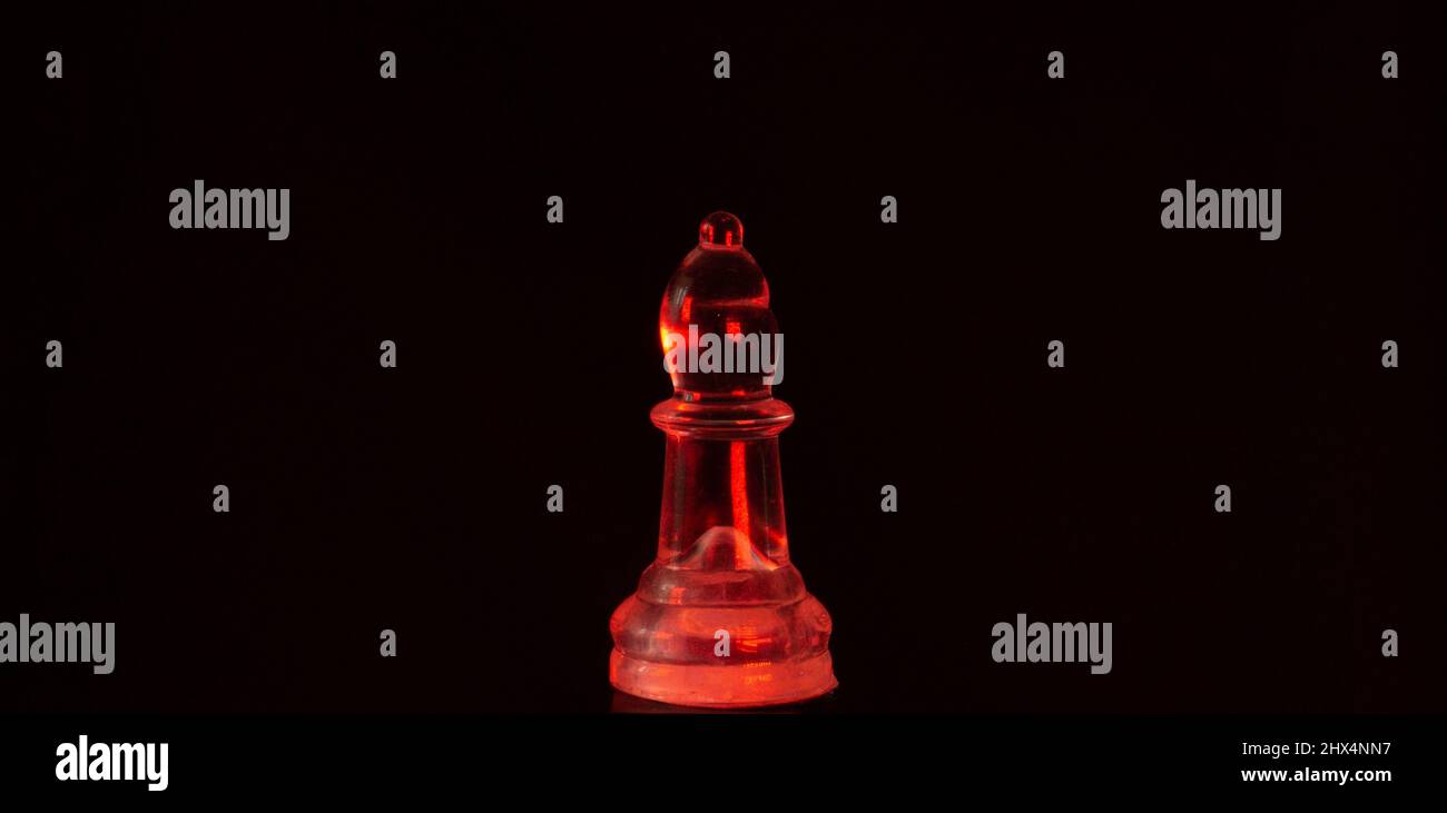 opaque crystal bishop chess piece using filtered red light isolated on ...