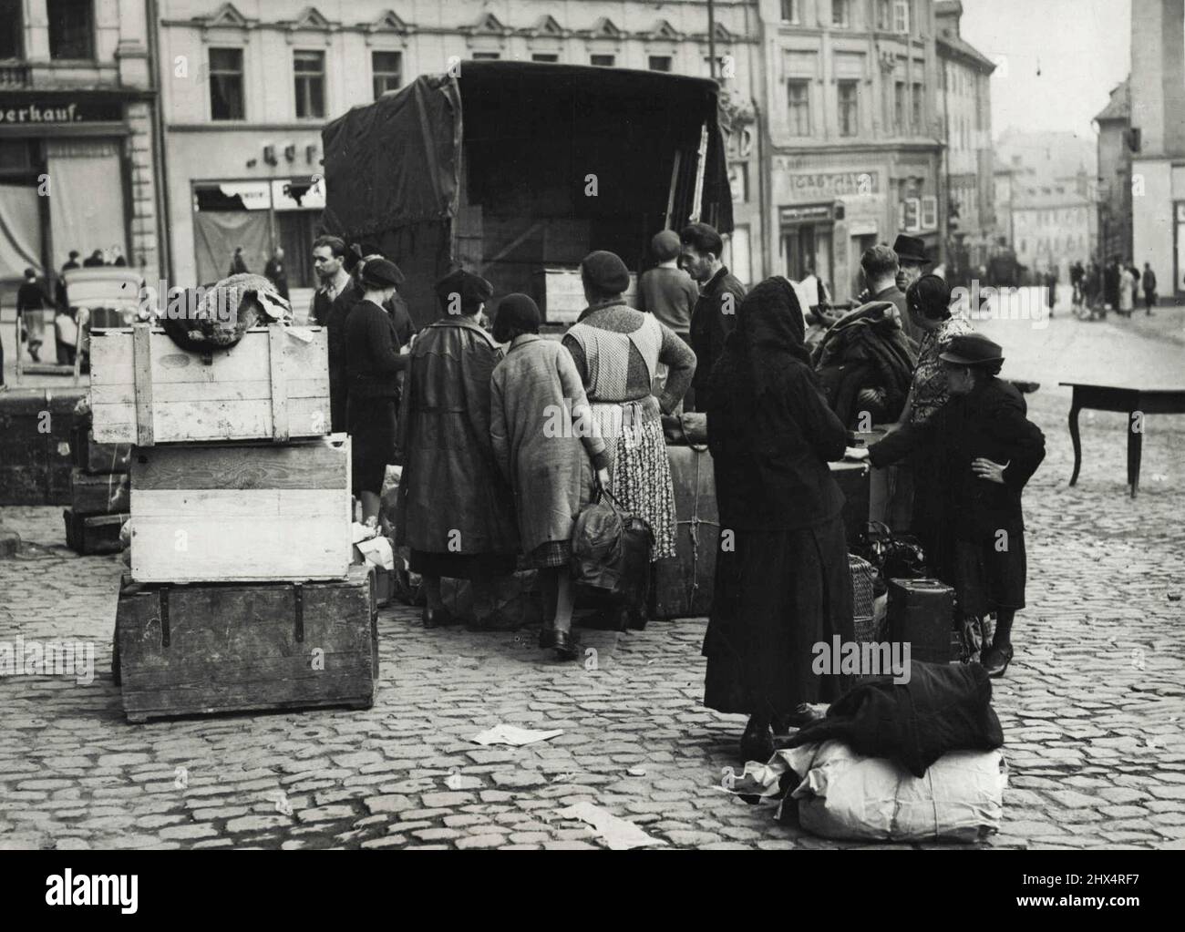 Czech refugees loading their furniture and goods on to lorries in ...