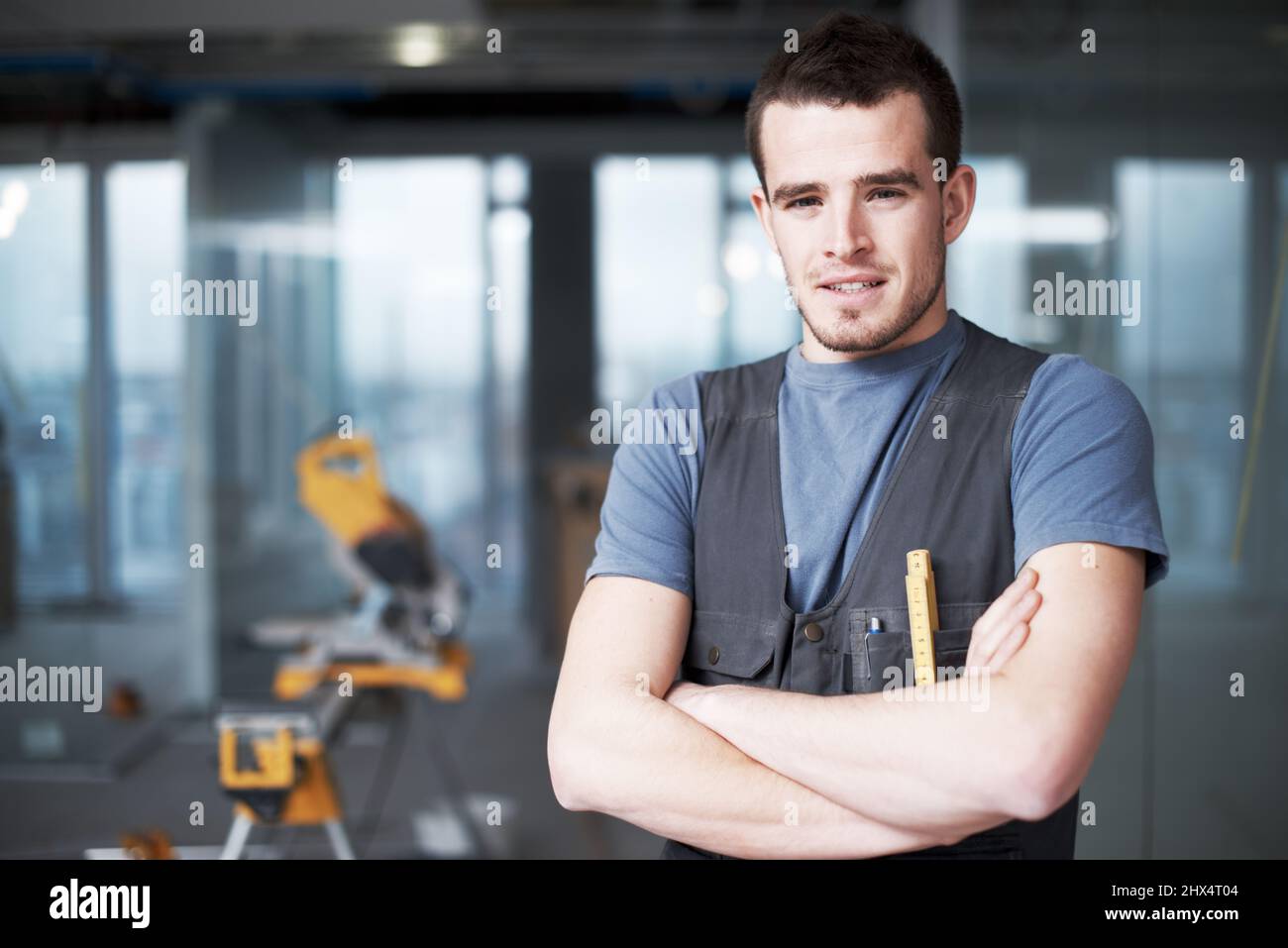 Trust him to build something solid. Handsome young contractor standing ...