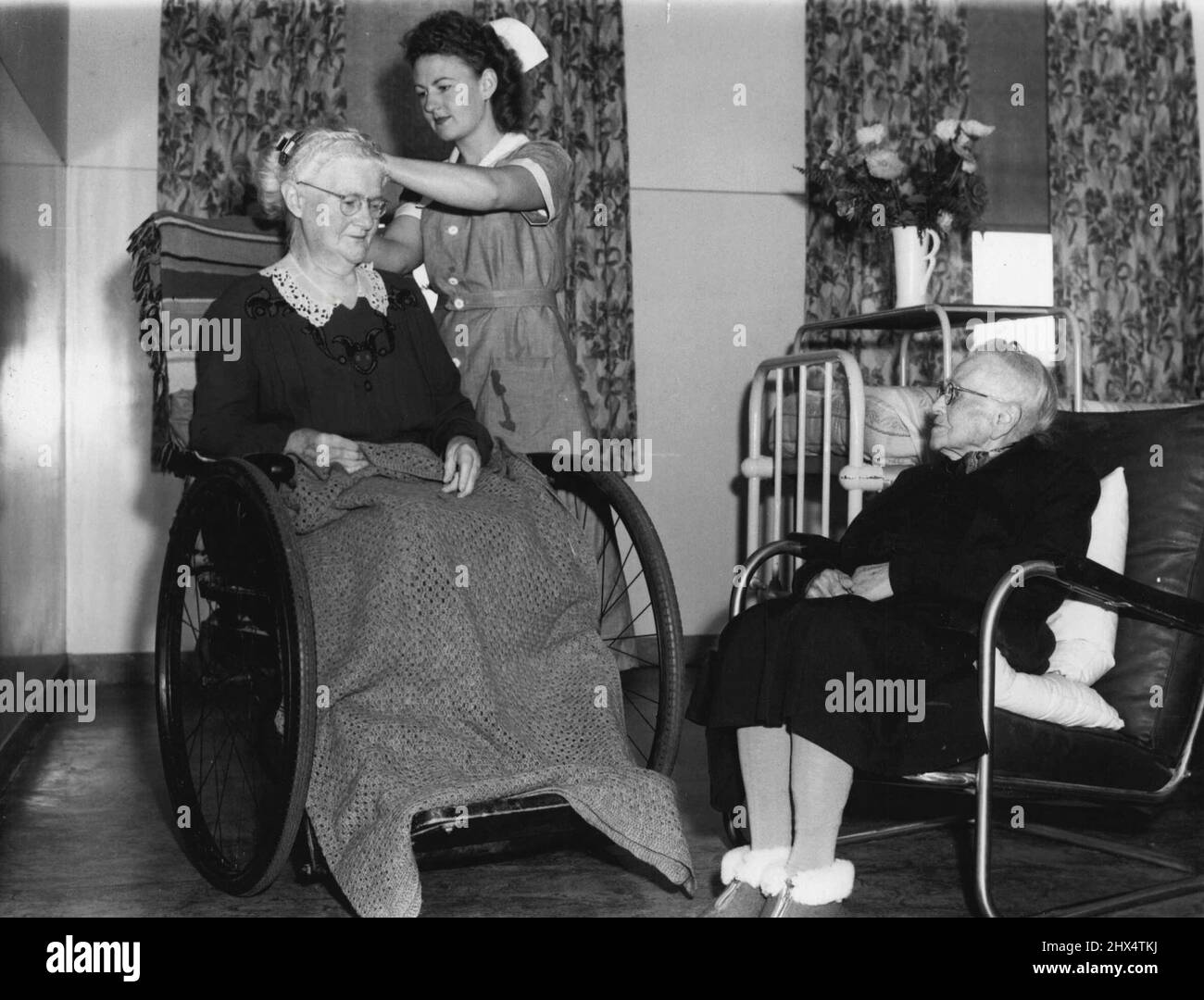 Nurse Beryl Mazzini sets her hair for Mrs. Louisa Mott, 71, as the home ...