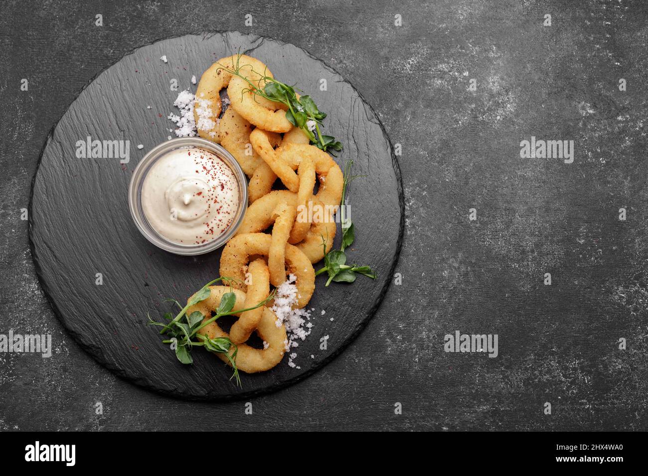 Fried squid rings in batter with sauce Stock Photo - Alamy