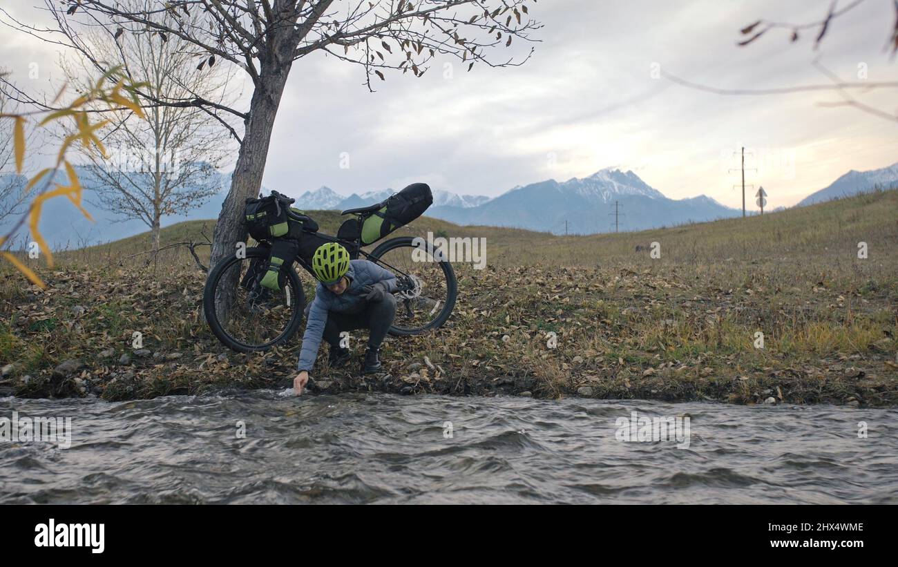 The woman travel on mixed terrain cycle touring with bikepacking. The ...