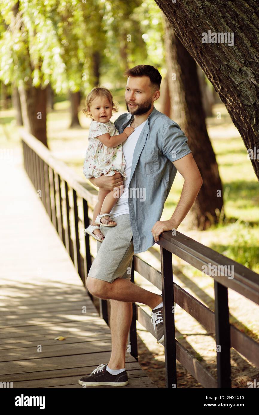 Loving father with adorable daughter at the park, caring parent hold ...