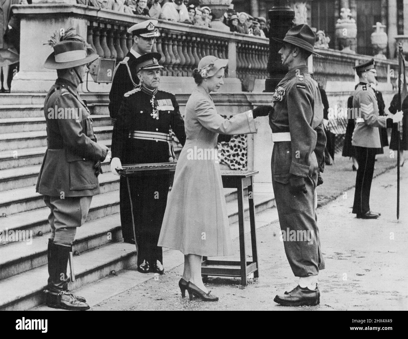 An Officer Receives His Medal -- The Queen with Prince Philip took the ...
