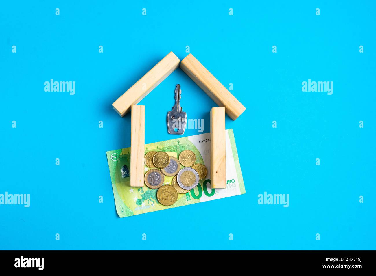Wooden toy house with keys on a blue. Empty space to put text or ...