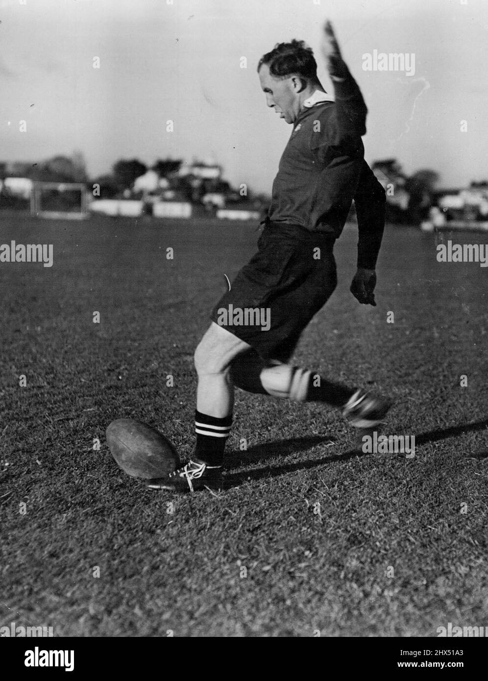 Kicking rugby ball Black and White Stock Photos & Images - Alamy