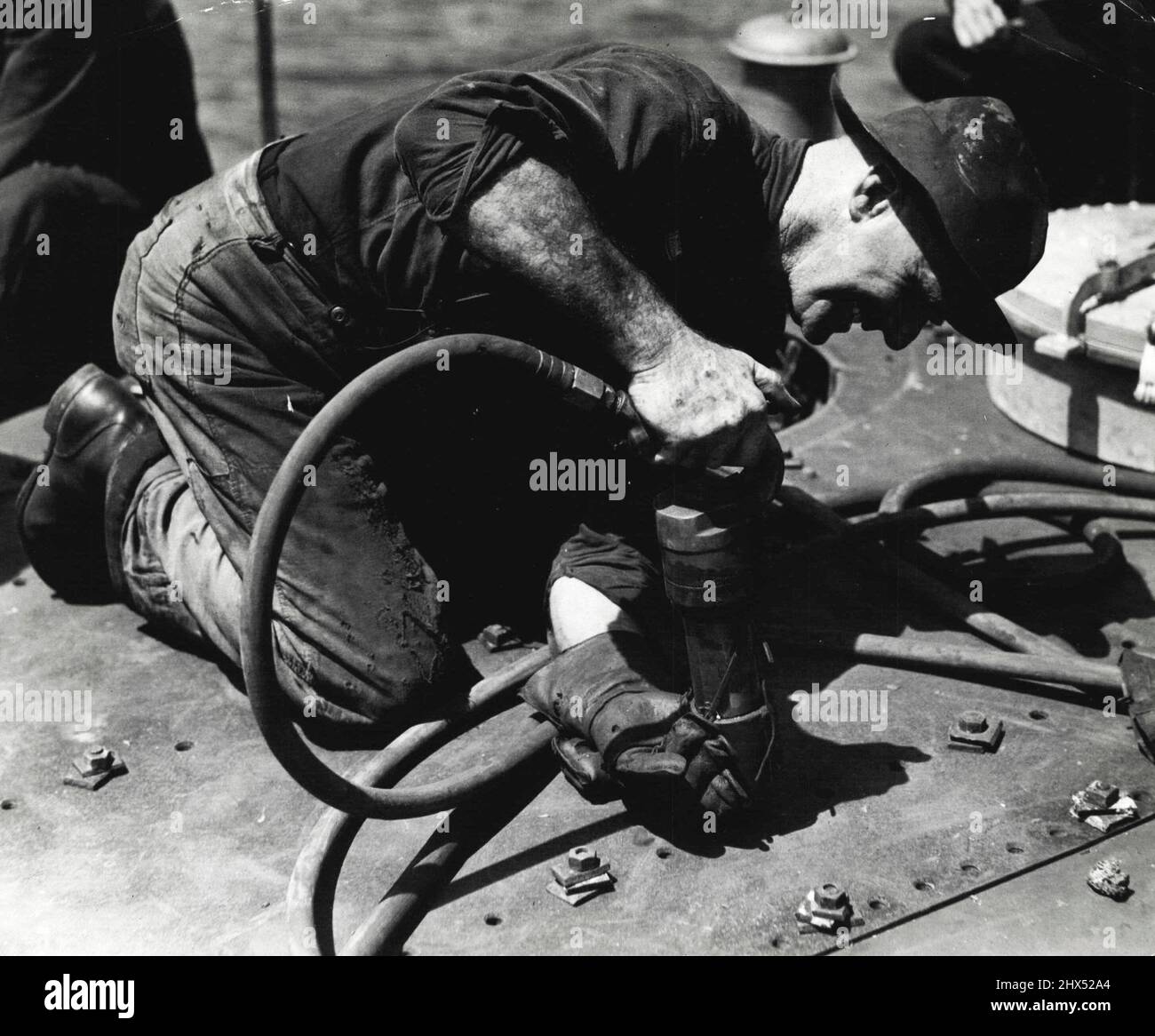 Riveter working on the after deck of the rigdant *****. March 07, 1938 ...