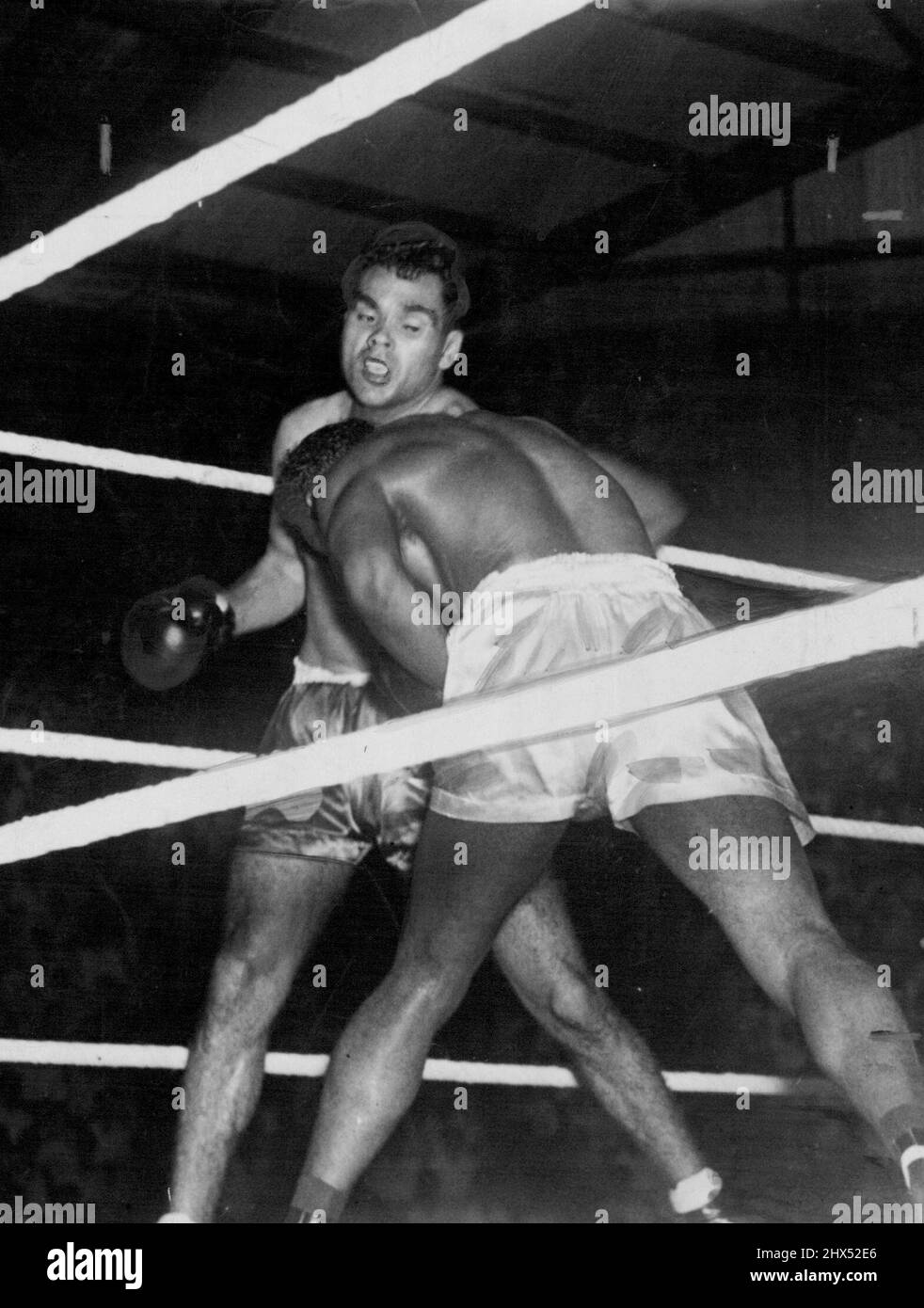 Dave Sands about to let go a jolting right as Boy Brooks covers up in ...