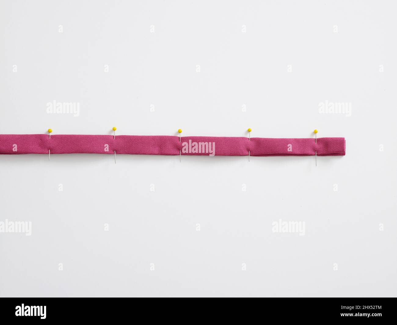 Fabric tie for seat pad, folded in half lengthways and pinned in place ...