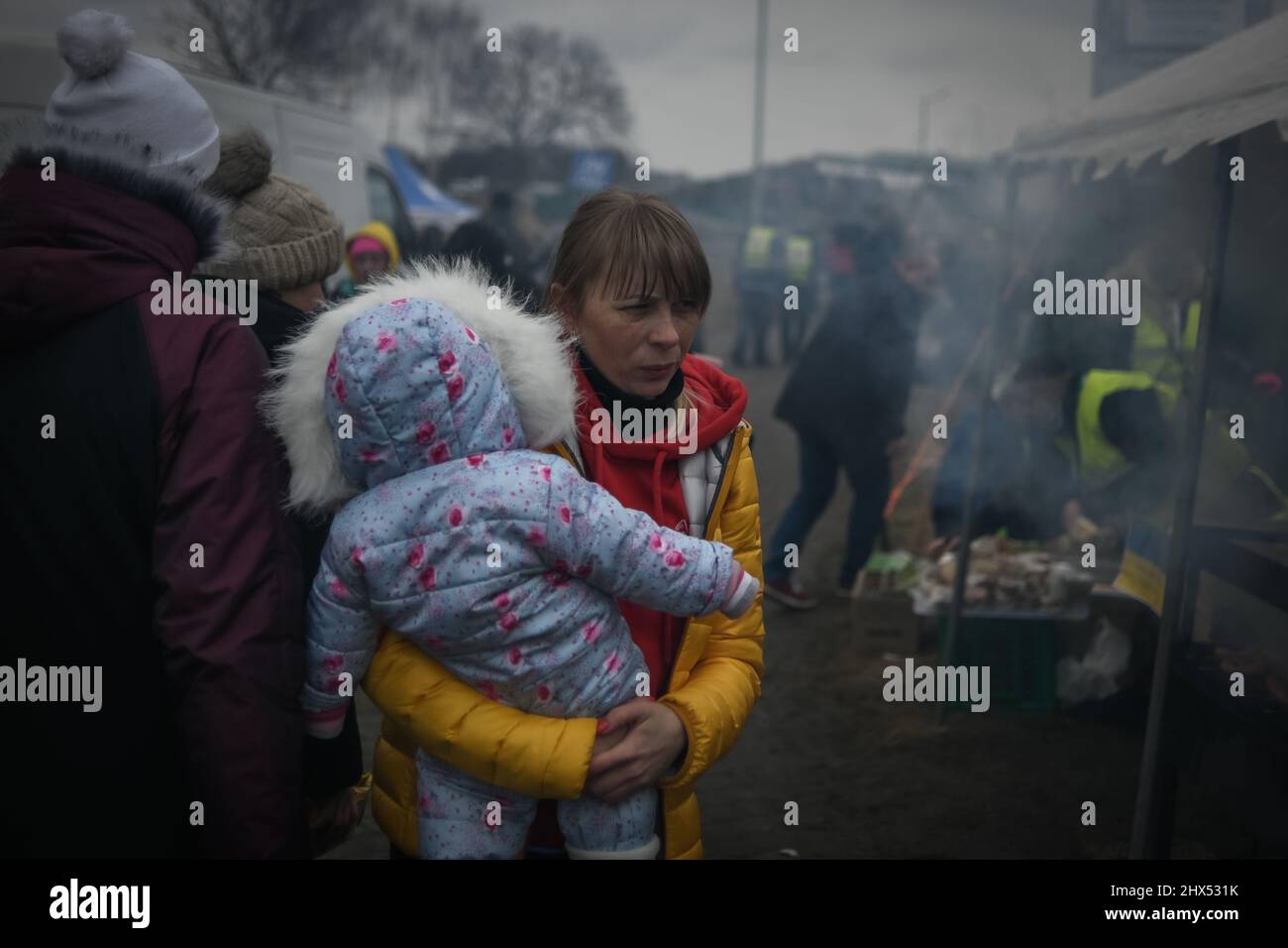 Medyka, Poland, March 9, 2022: a woman holds a small child as refugees ...