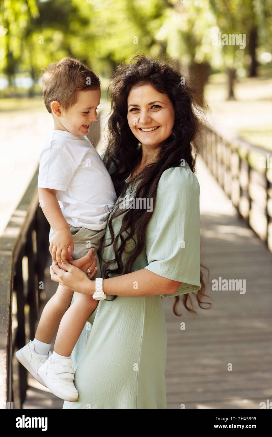 Portrait of adorable mother with overjoyed son at the park, beautiful ...