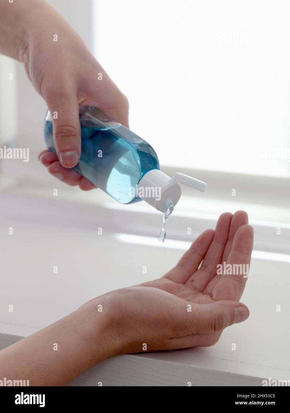 Pouring liquid disinfectant soap onto open palm Stock Photo - Alamy
