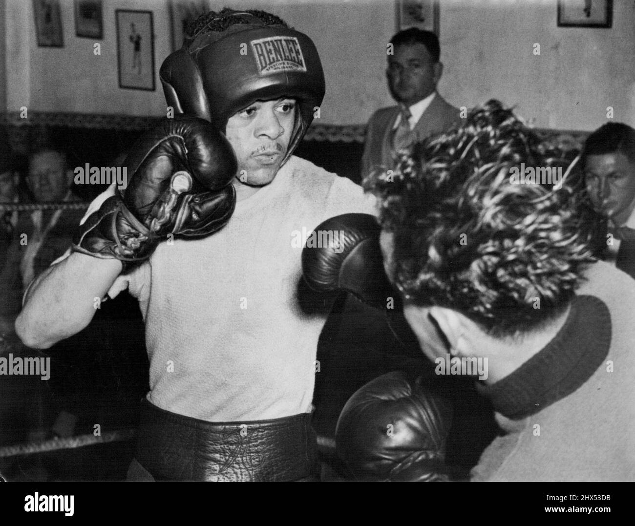 Sparring partner Charlie Dunn (right) slips inside a left hook from ...