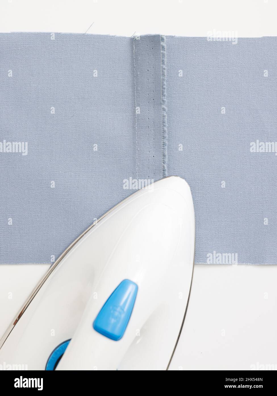 Ironing seam of pale blue upholstery fabric Stock Photo - Alamy