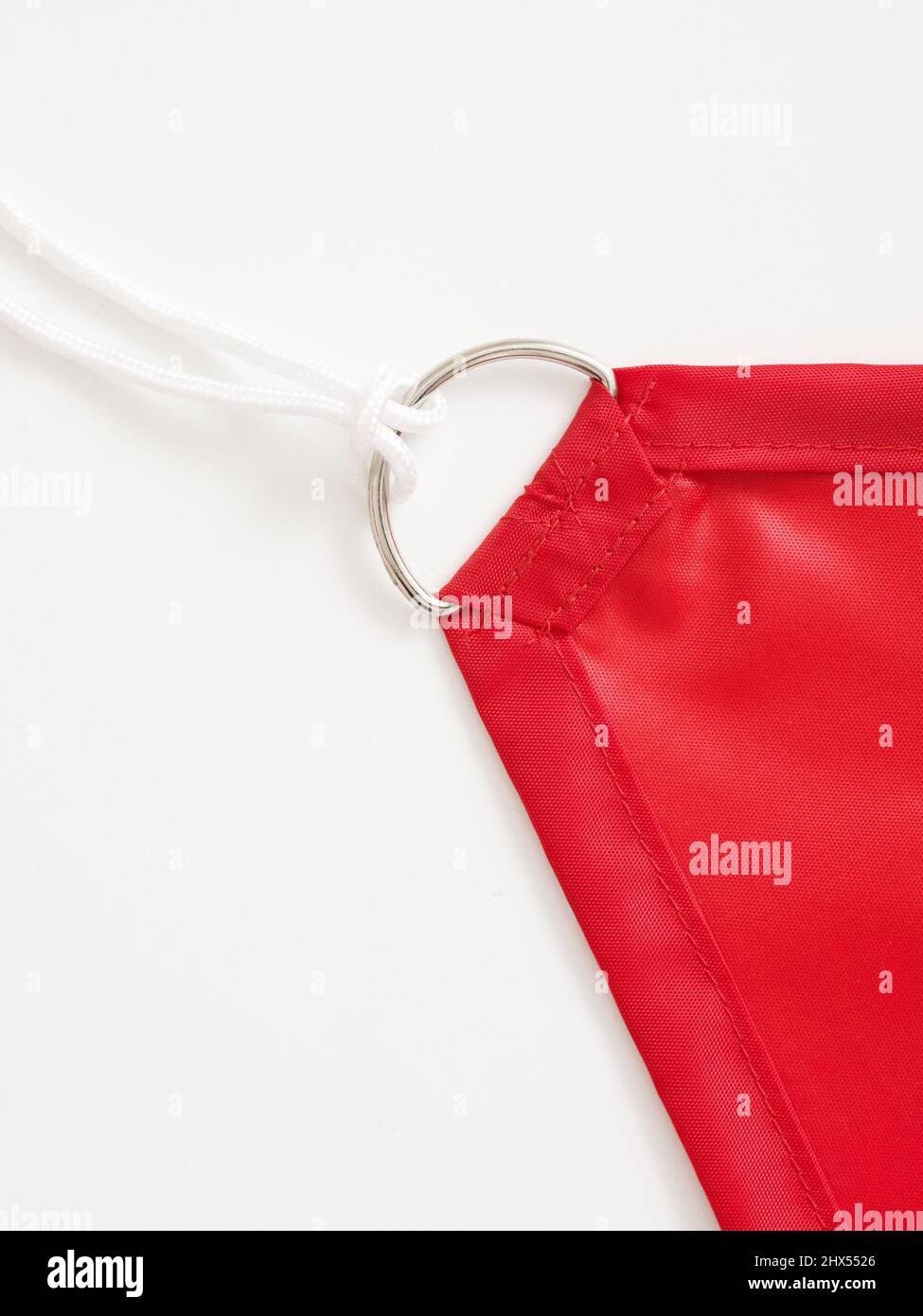 Making a garden sail shade, attaching ring and cord Stock Photo - Alamy