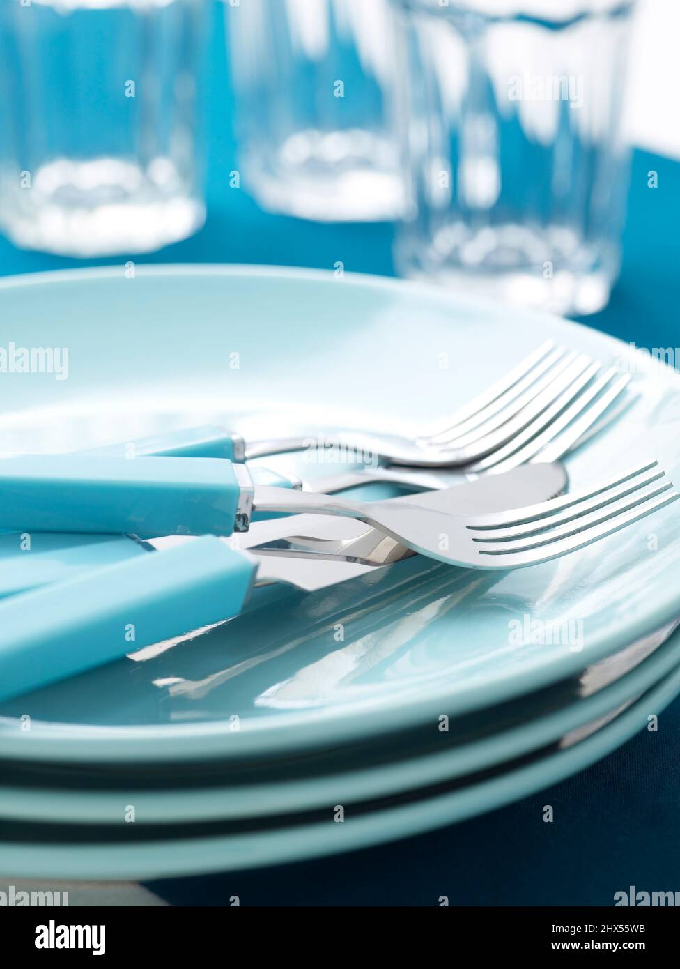 Turquoise plates and cutlery Stock Photo - Alamy