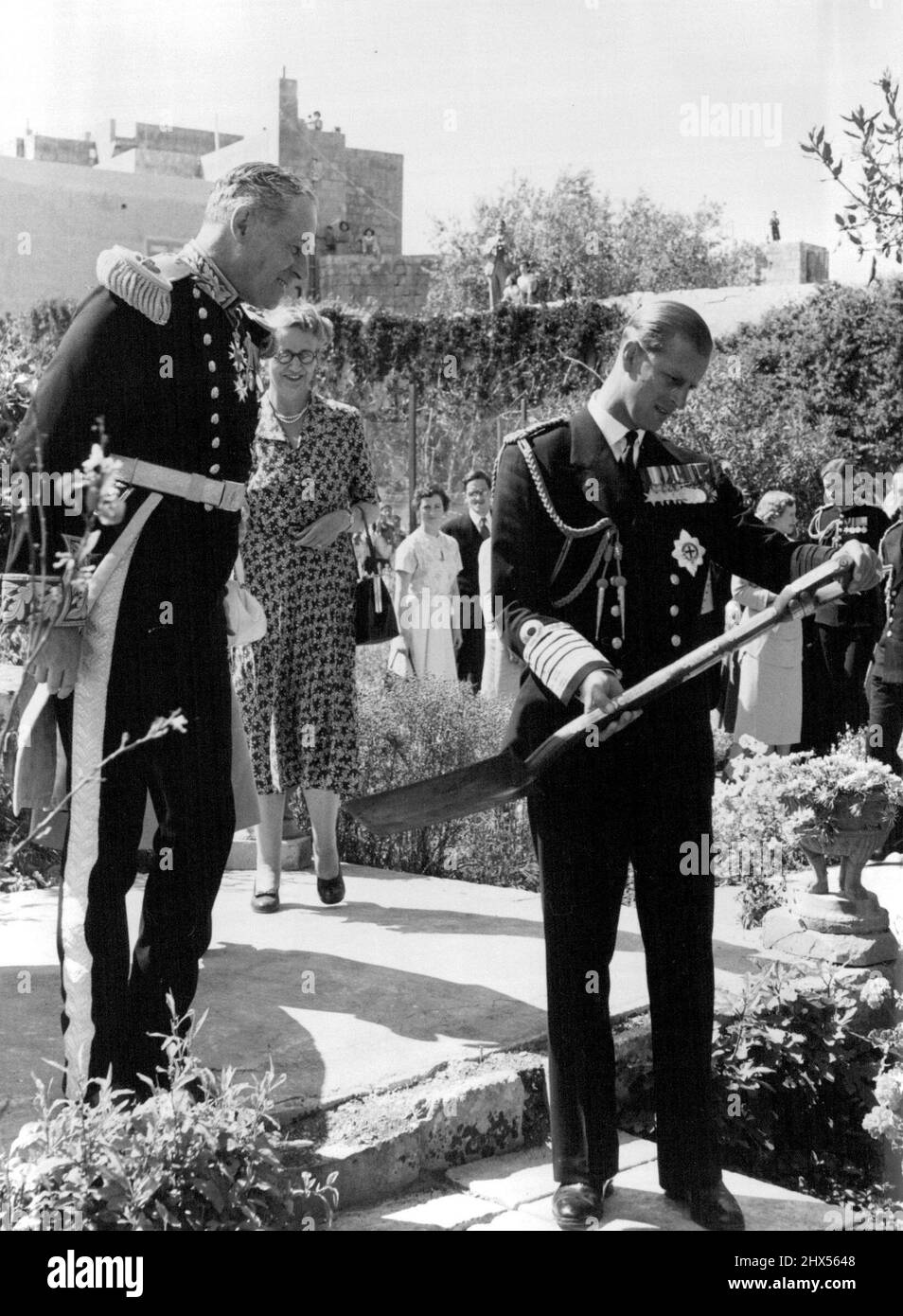 The Royal Family in Malta. The Duke of Edinburgh examines the spade ...