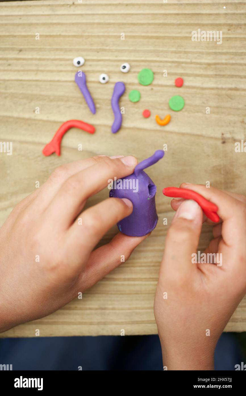 Hands crafting alien figurine for bottle garden Stock Photo - Alamy