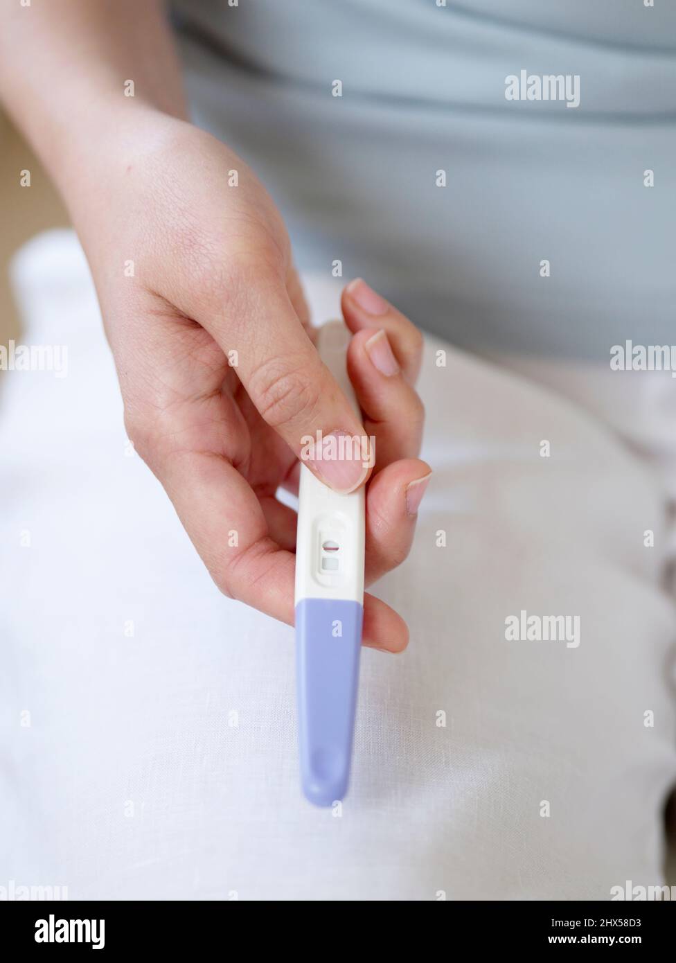 Woman holding home pregnancy test stick Stock Photo - Alamy