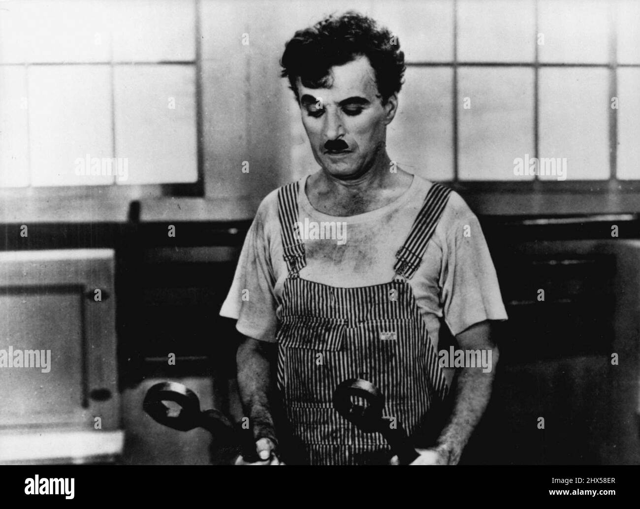 Charlie Chaplin - Actor. Born Britain. In scene from the 1936 film ...