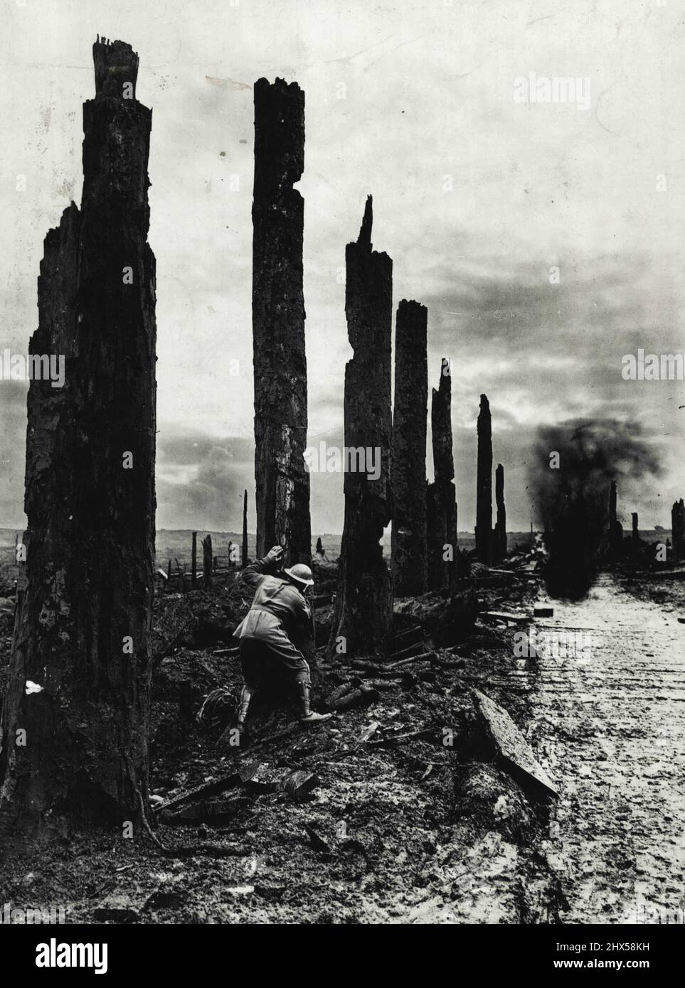 Devastation A solider takes shelter from an exploding shell in what was ...