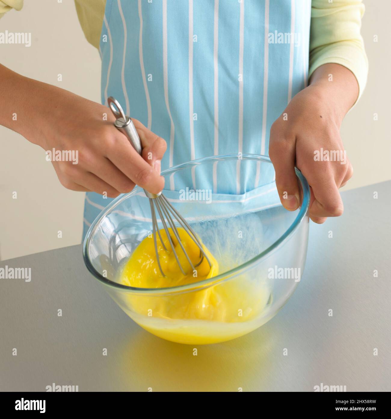Child whisking egg in mixing bowl to make omelette Stock Photo - Alamy