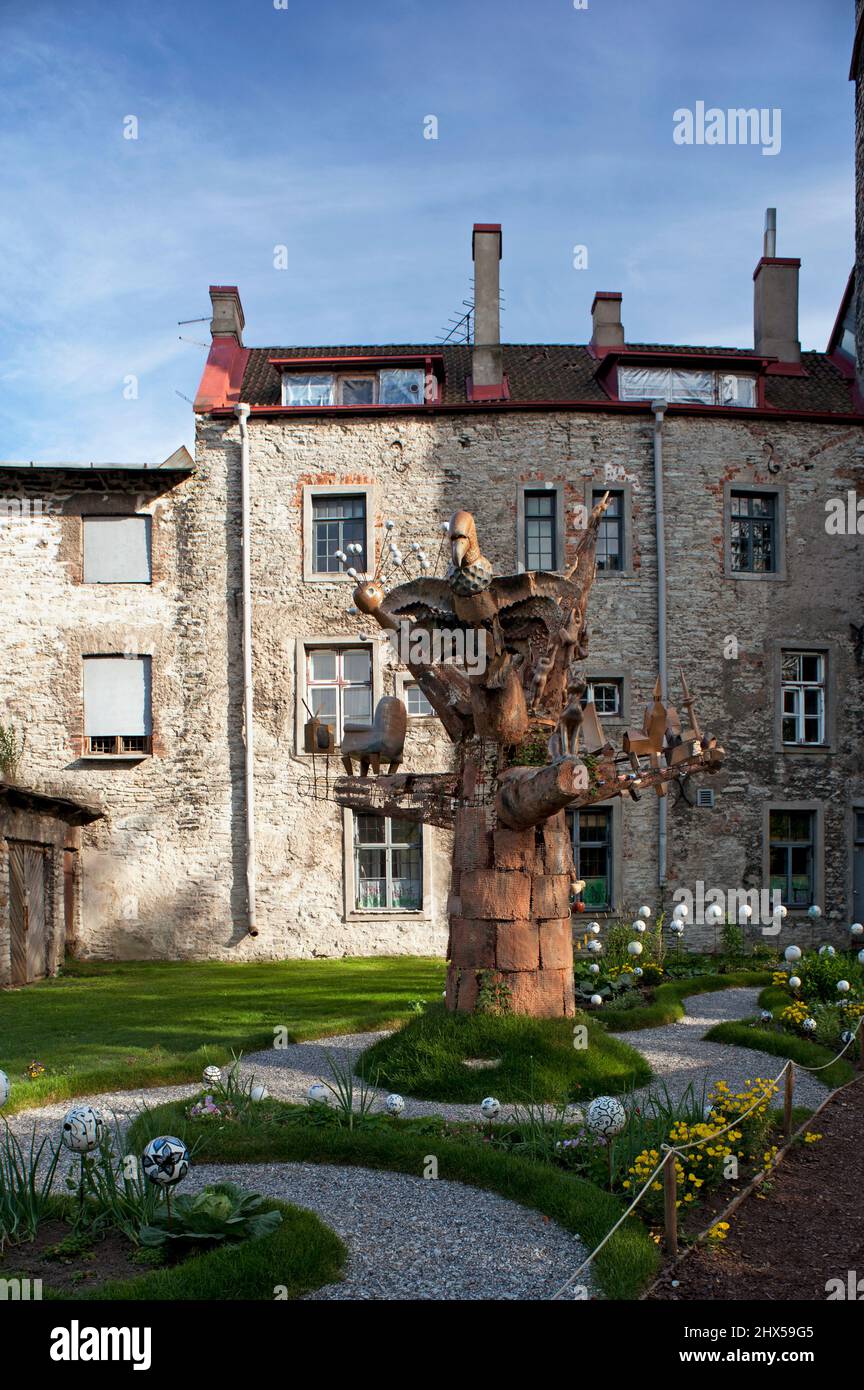 Estonia, Tallinn, tree-like carved statue in garden next to the old ...