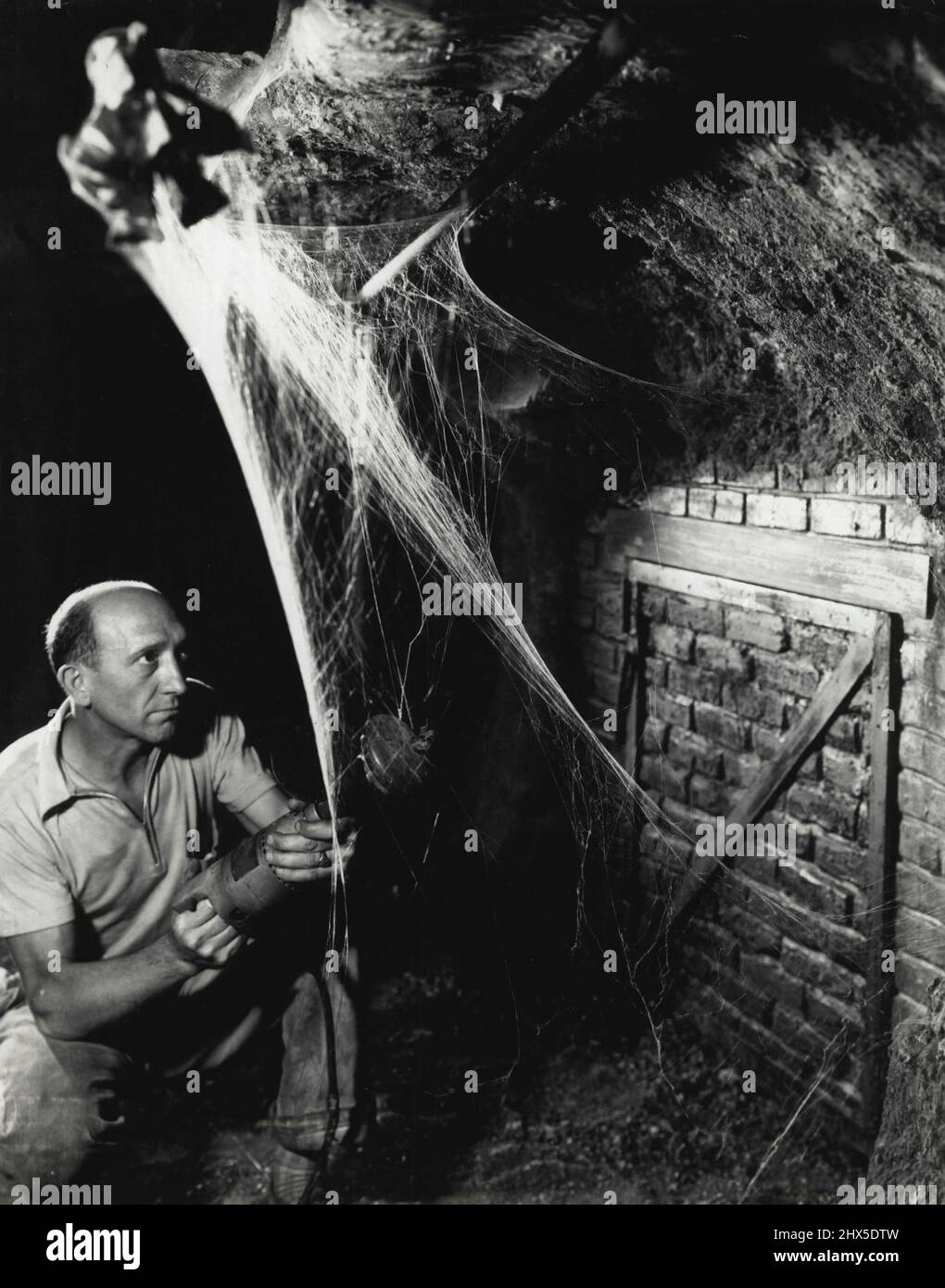 This man is known as the cobweb-maker. Here you see him at work making ...