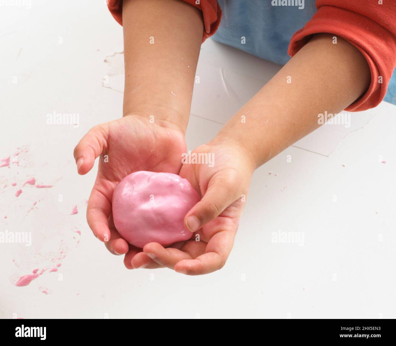 Boy holding ball of pink goo Stock Photo - Alamy