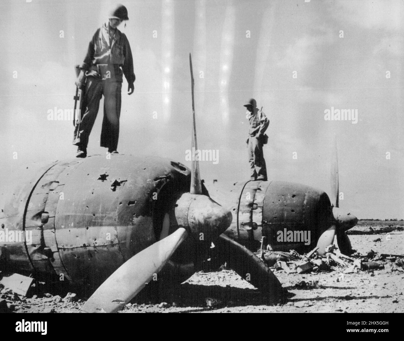 Riddled Jap Bomber - Two American Marines inspect a twin engine Jap ...