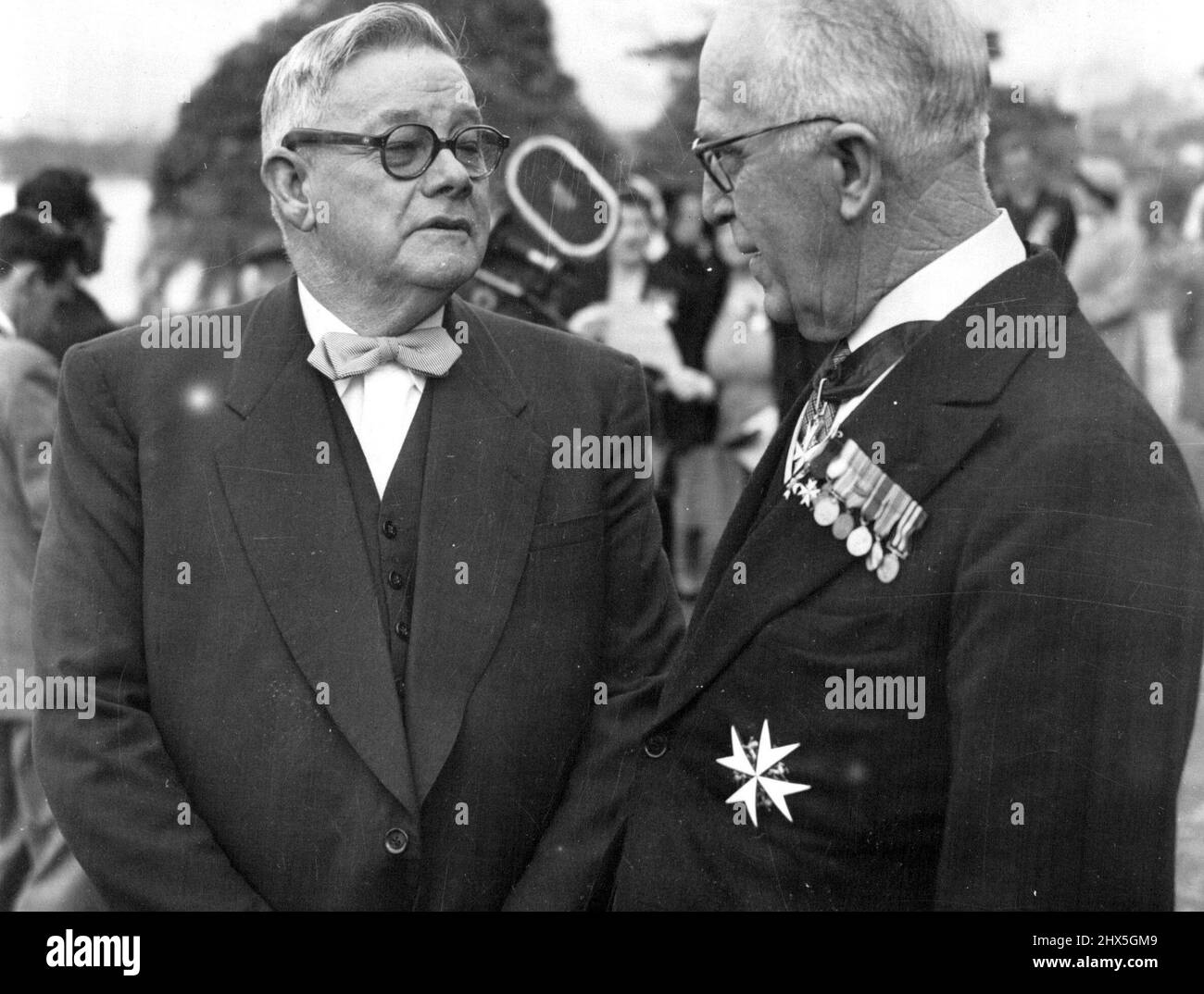 New Knights. Sir Edward Hallstrom and Group Captain Sir Hugh Poate chat ...