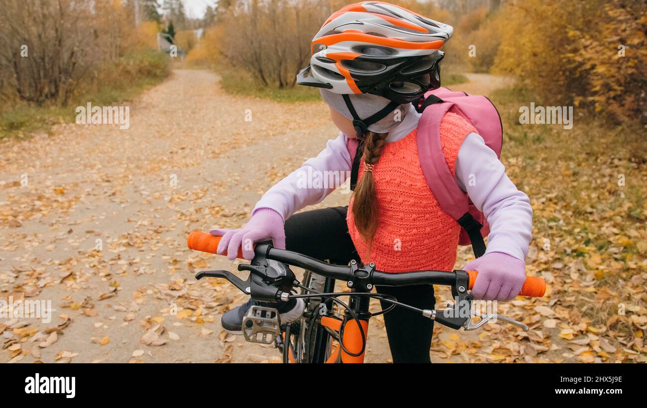 One caucasian children walk with bike in autumn park. Little girl ...