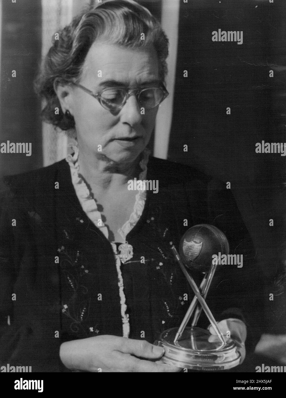 Mrs. E. Kermode of Balmain, pictured with the ball used by her husband ...