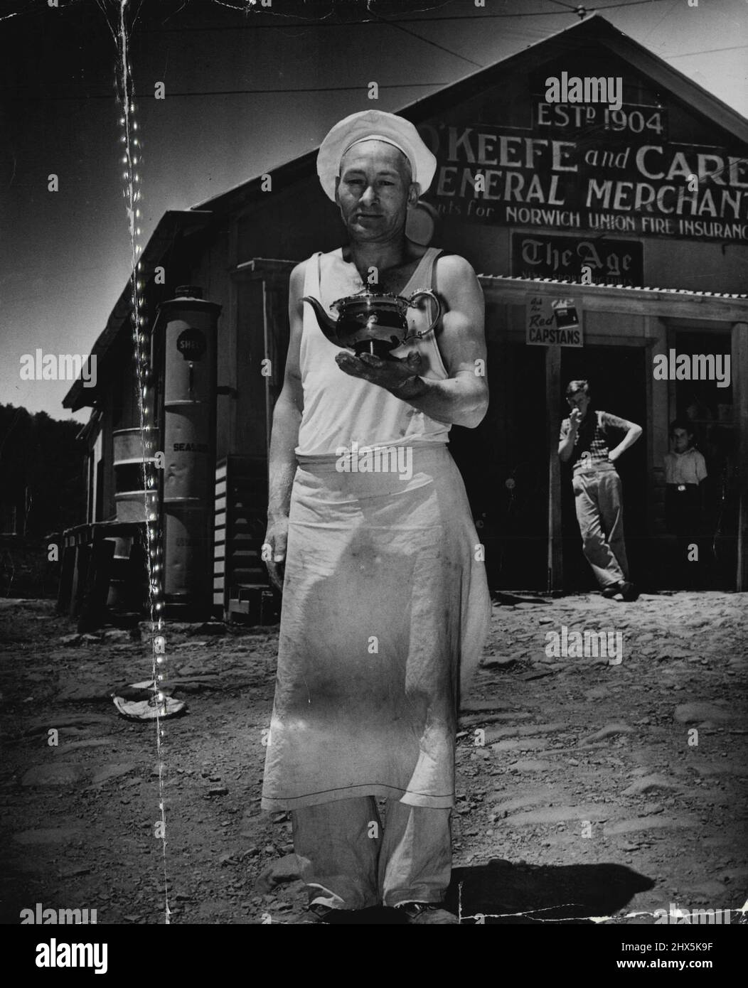 Baker poses proudly in main street with Golden Teapot. Lounger picking ...