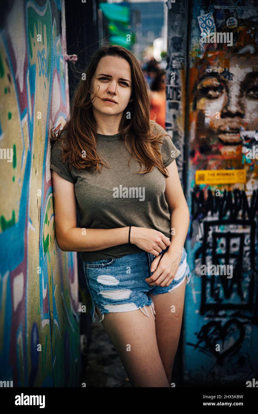 Street style photo shoot with a young pretty woman in the colorful ...