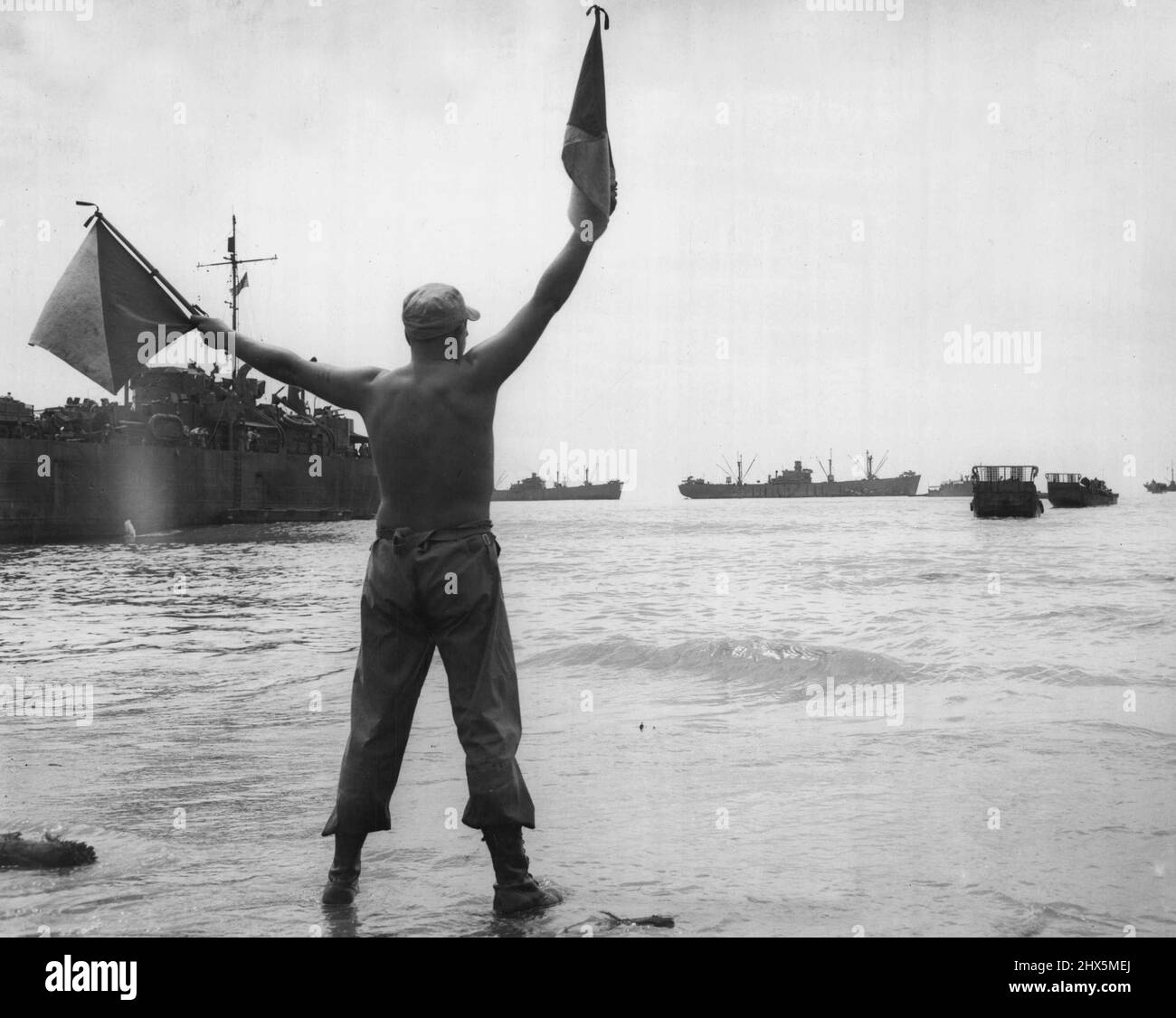 Directing Invasion Traffic -- A beach control director, Pvt. Jess O ...